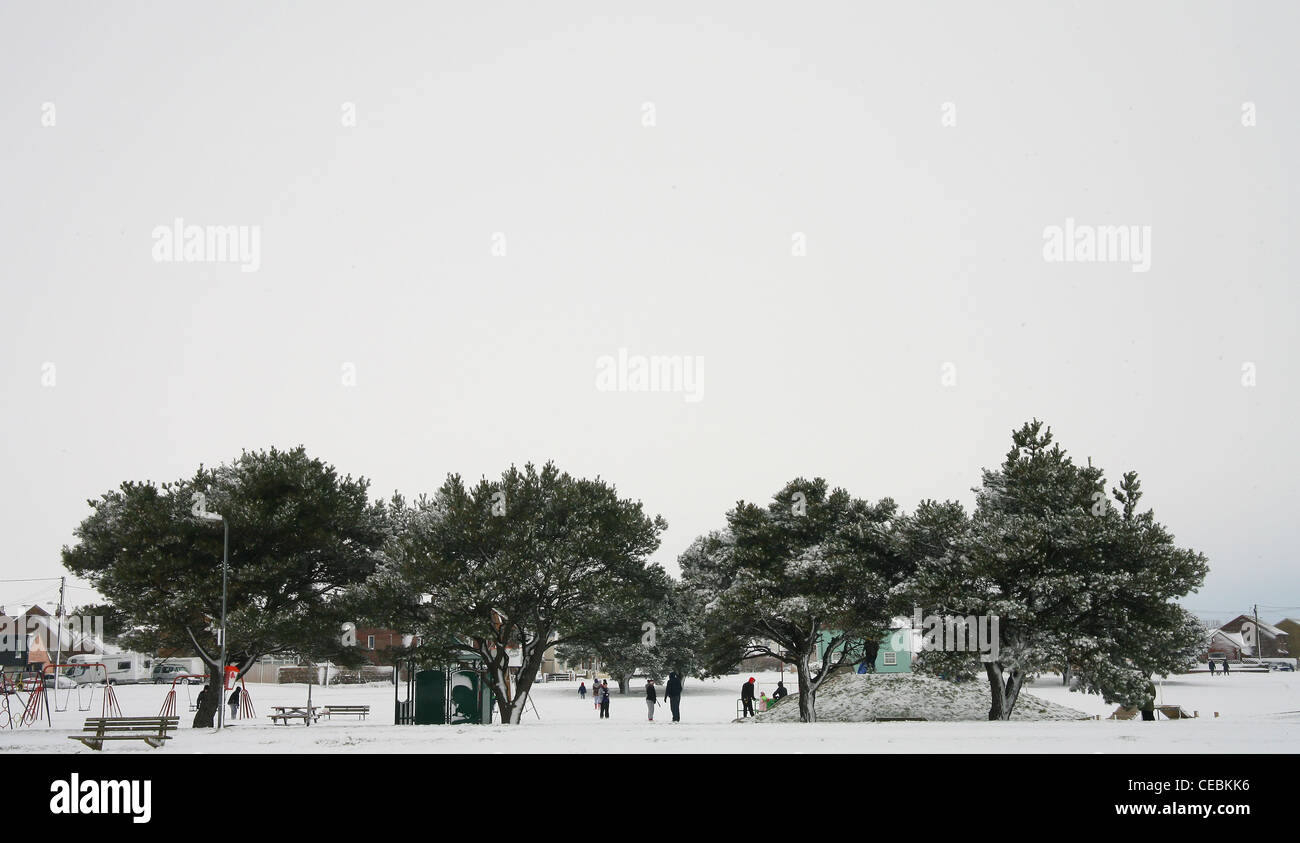 A snowy winter childrens play park scene from a distance, landscape ...