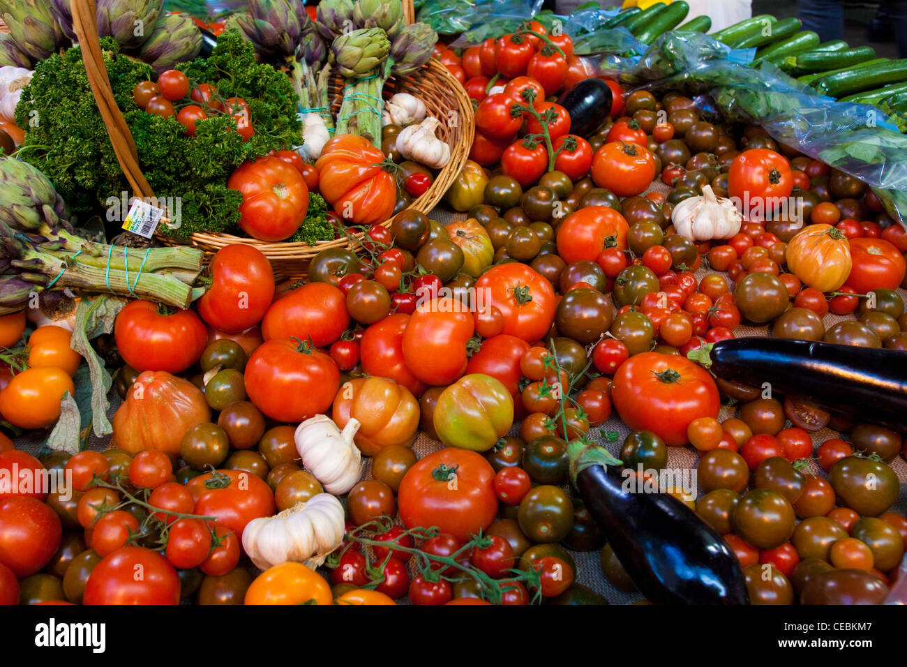 Tomatoes and other vegetables displayed on a market stall, London, UK ...