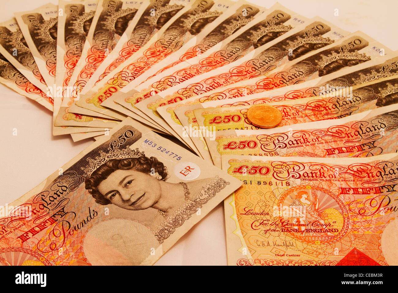 Fifty Pound notes and one penny Stock Photo - Alamy