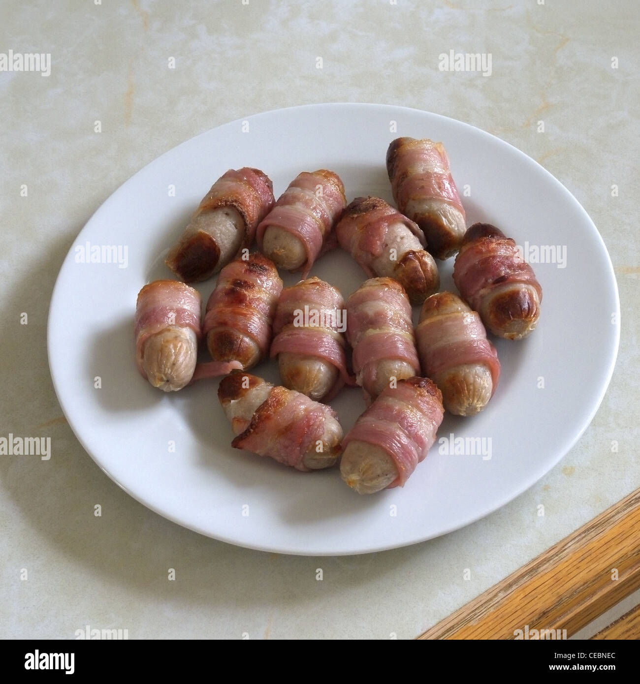 A Selection of Pigs In Blankets (sausages wrapped in bacon) on a White ...