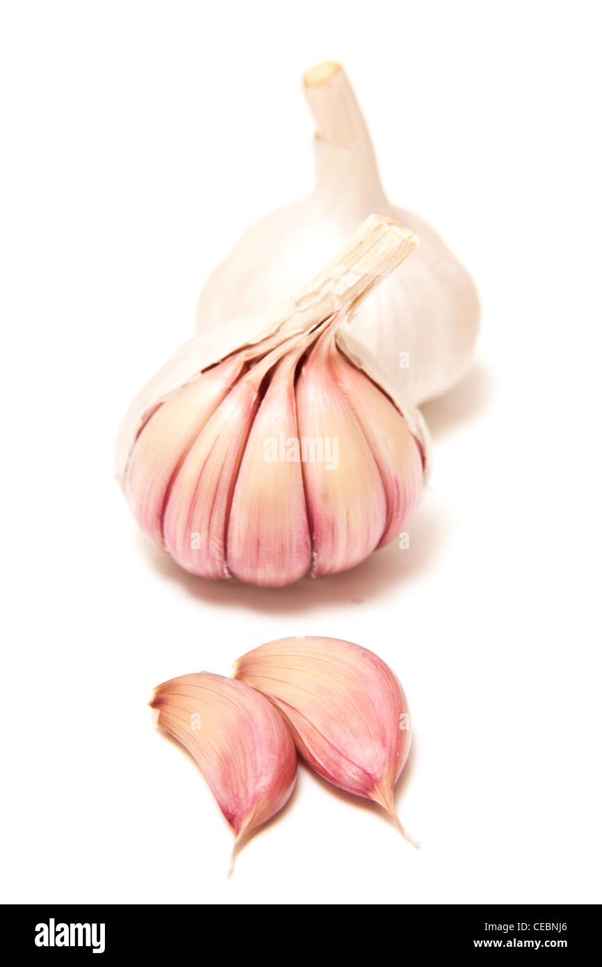 Rose or pink garlic bulbs and cloves isolated on a white studio ...
