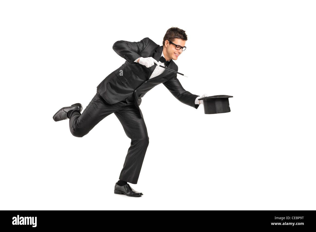 Full length portrait of a magician holding a magic wand and gesturing ...