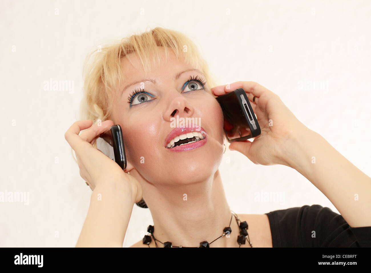 Business young woman speaking on phones Stock Photo - Alamy