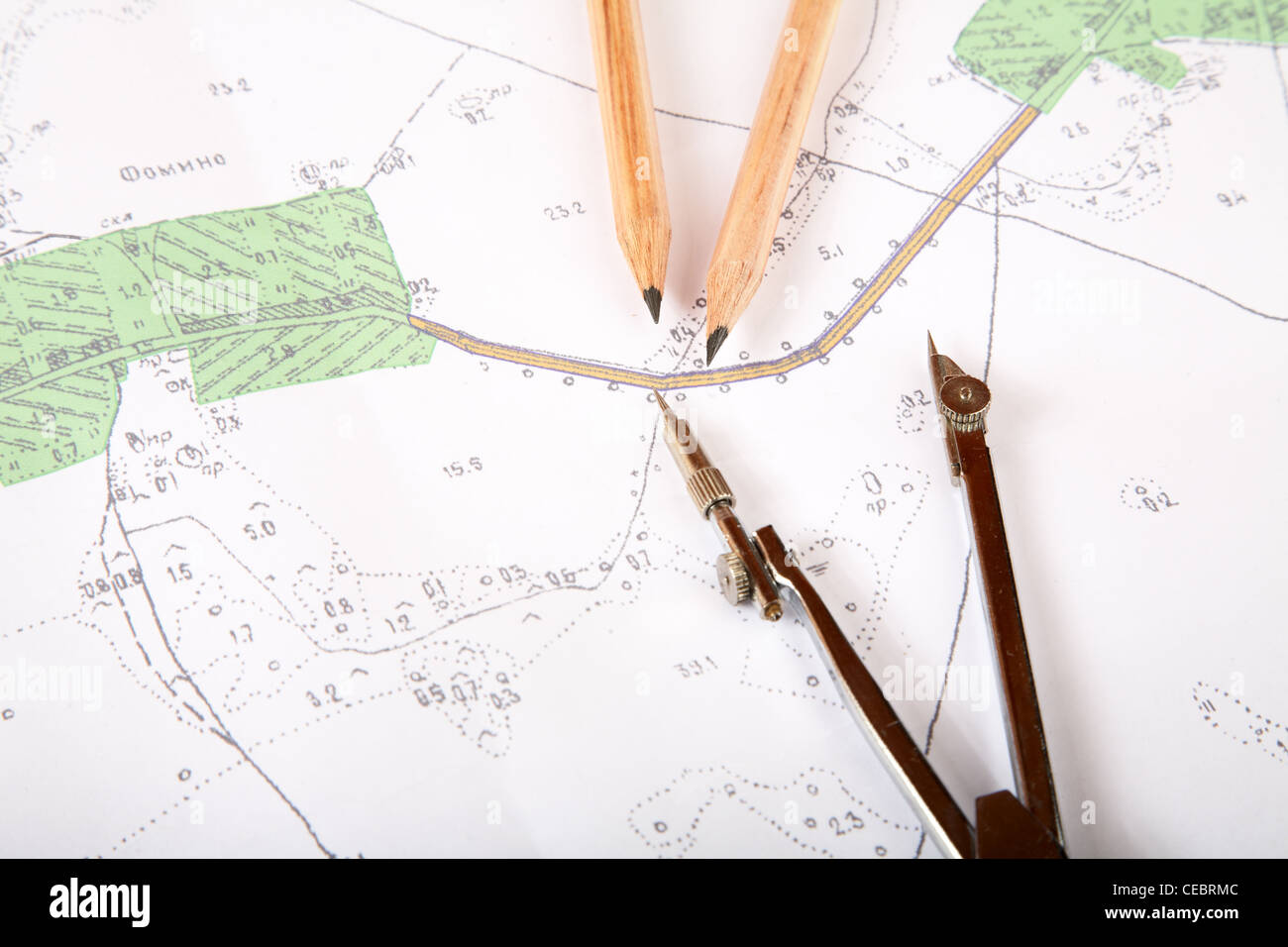 Topographic map of district with a measuring instrument and pencils ...