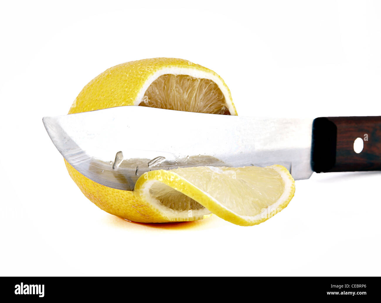 Knife a cutting juicy lemon on a white background Stock Photo - Alamy
