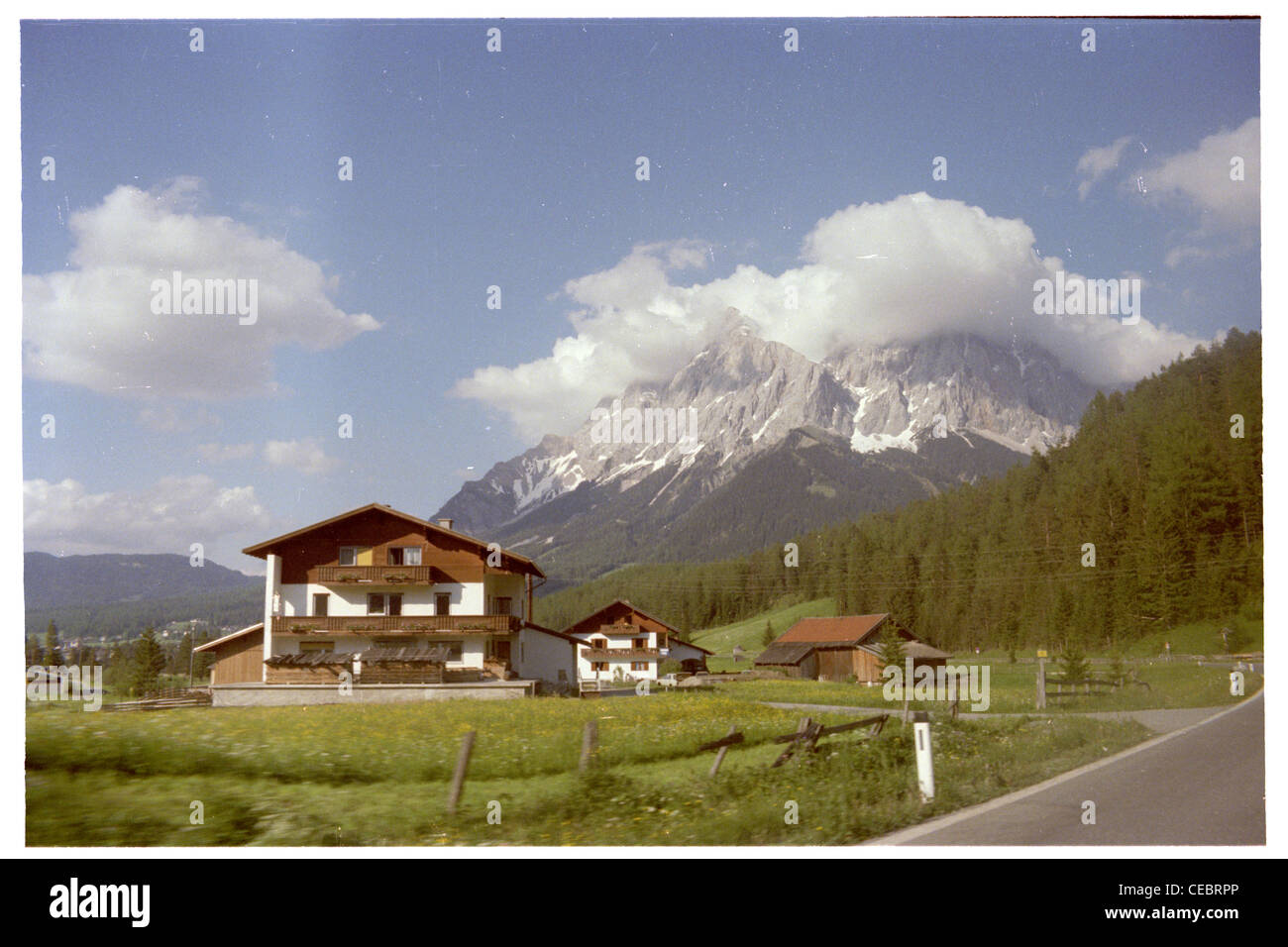 View of typical Tirolean house in the Alps showing mountains in the ...