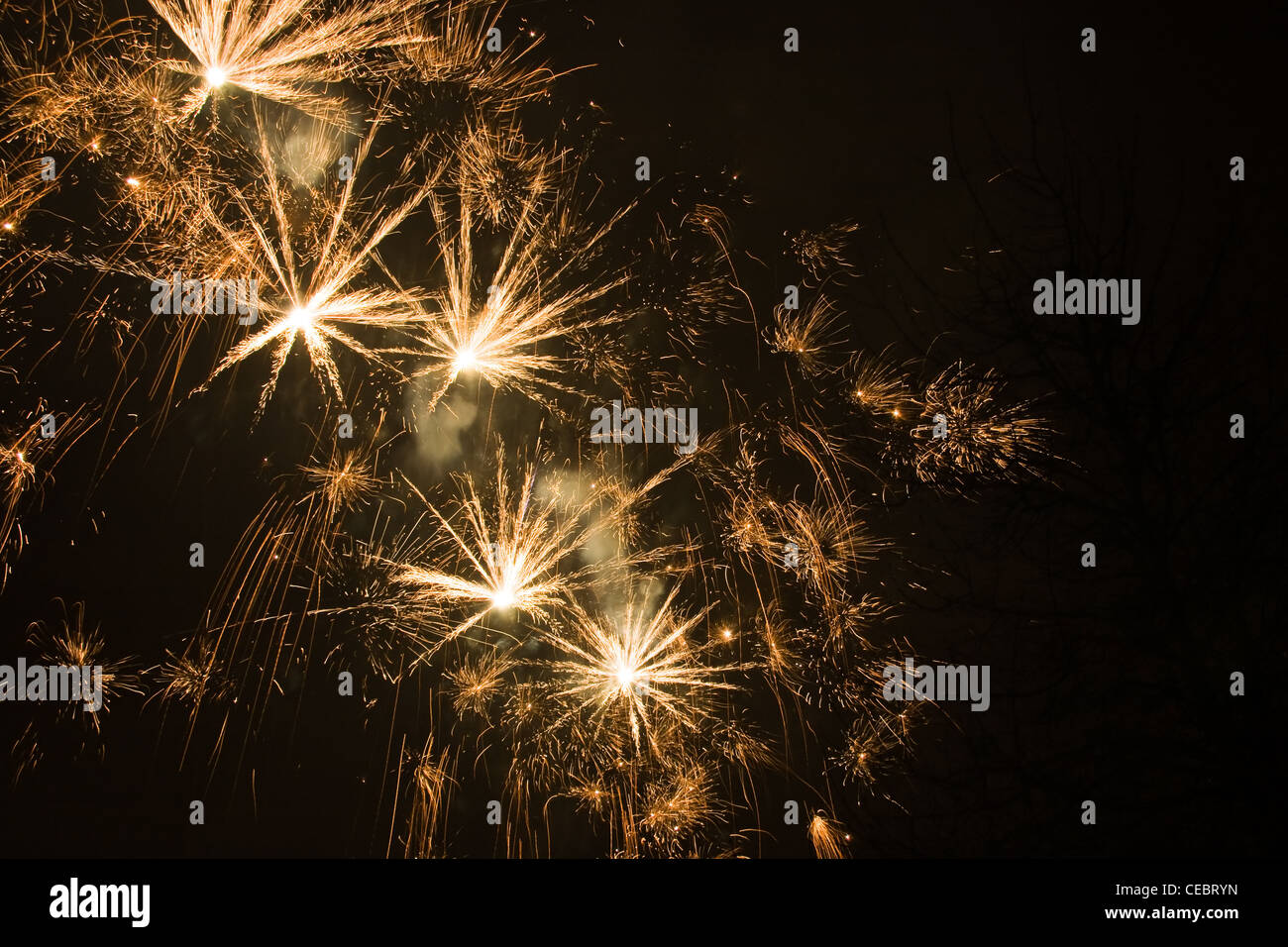 Exploding Golden Stars of fireworks at New Years evening Stock Photo ...