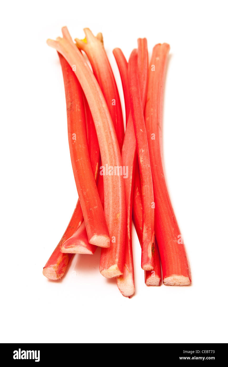 Rhubarb sticks or stalks uncooked isolated on a white studio background ...