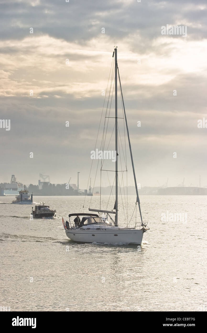 Ships sailing down the river in misty and silver morning light Stock ...