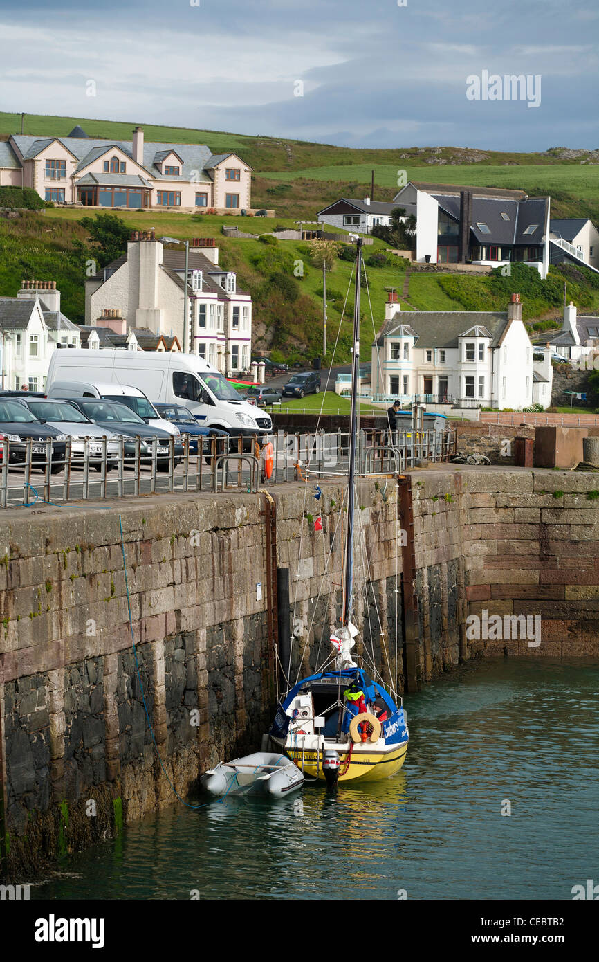 A yacht on the wall of Portpatrick harbour a small harbor and village ...
