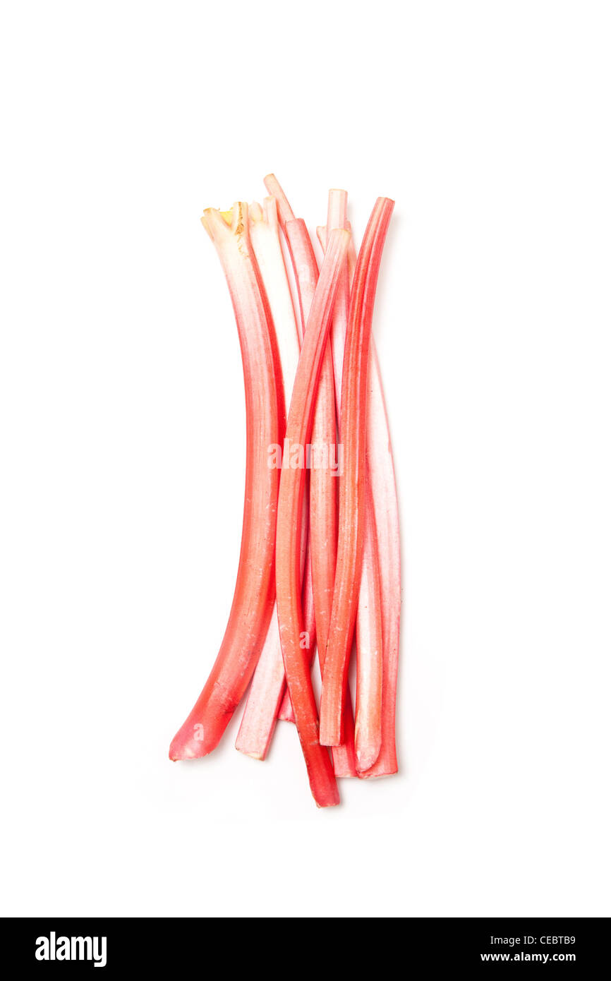 Rhubarb sticks or stalks uncooked isolated on a white studio background ...