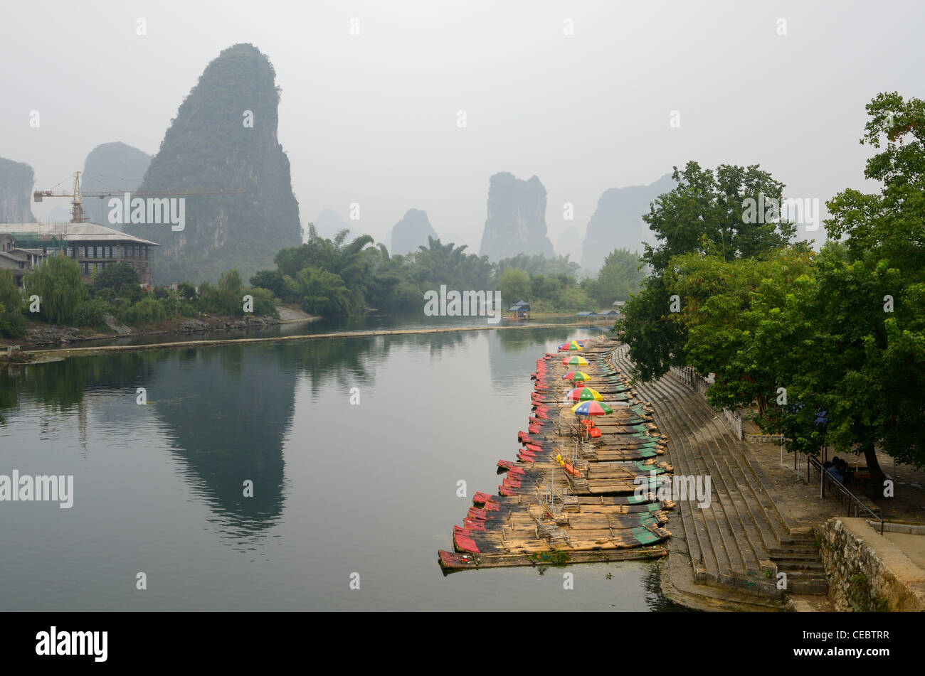 Row of bamboo raft tour boats and pointed Karst peaks at Yangshuo on ...