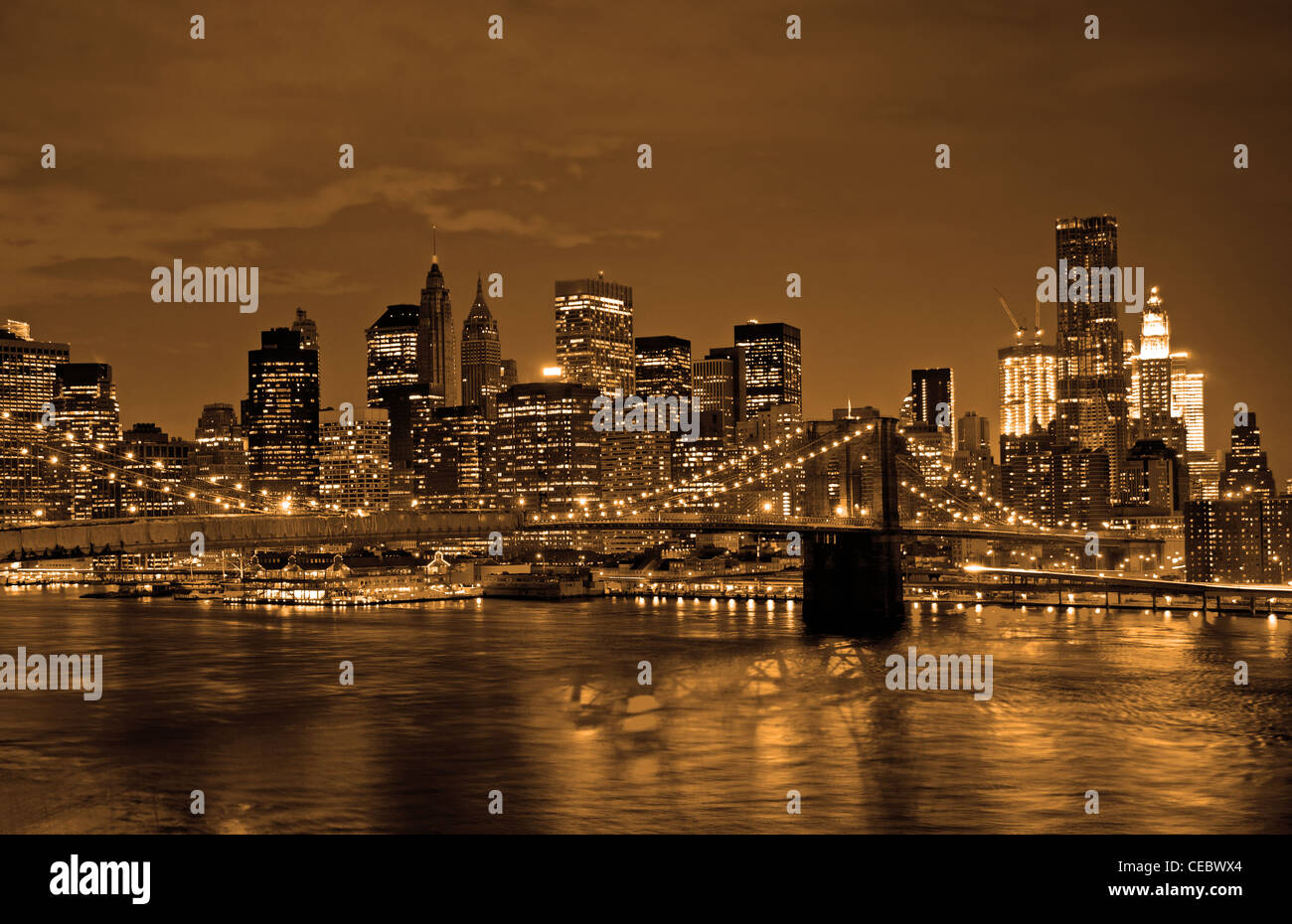 Historic Brooklyn Bridge and lower Manhattan reflected in East River ...
