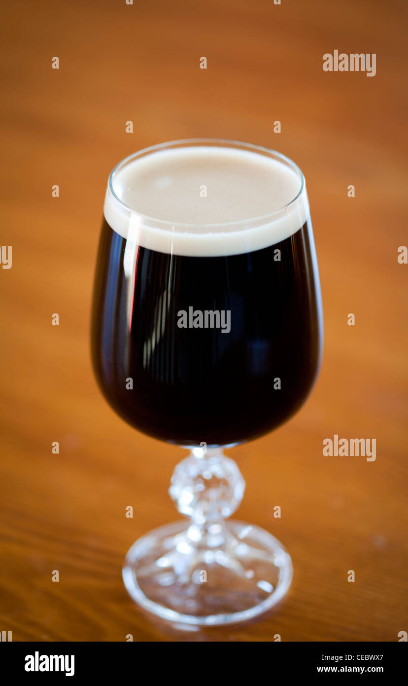 Pint of Irish stout beer on a table background Stock Photo - Alamy