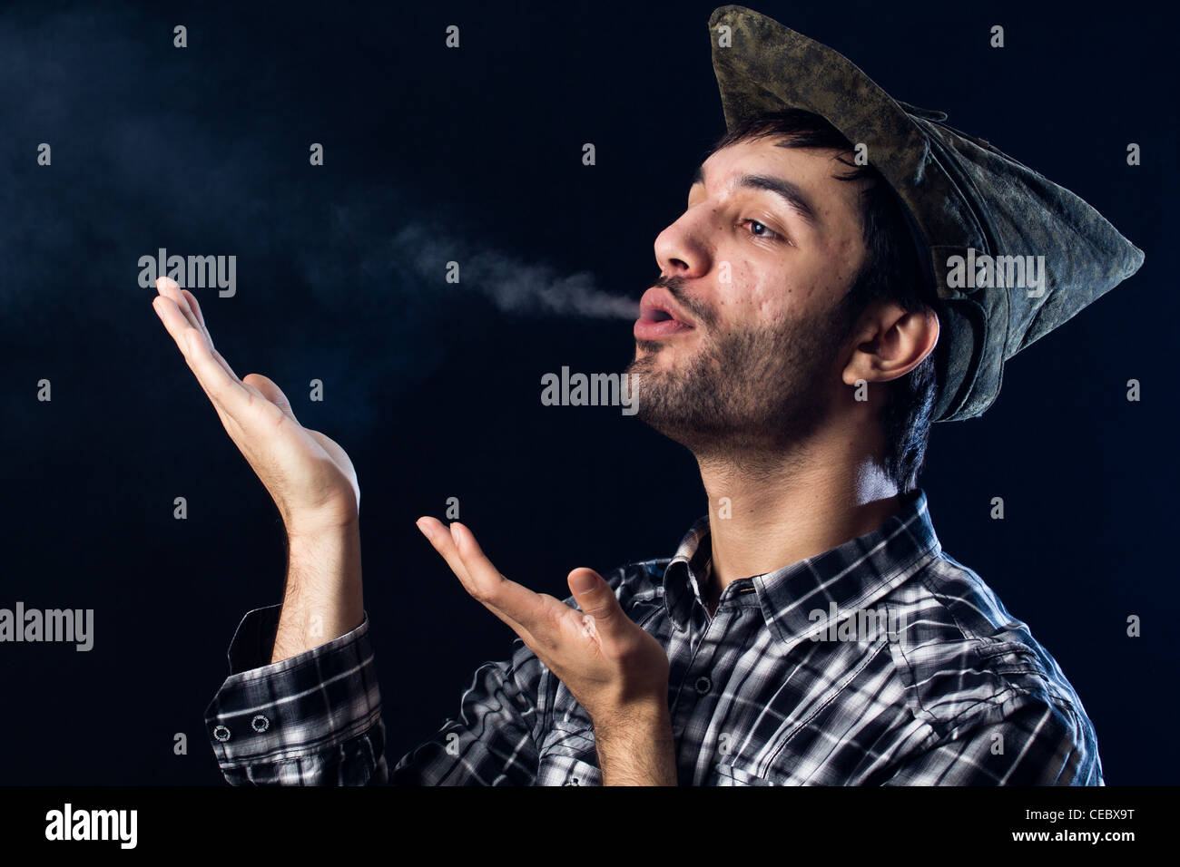Man On Black Blowing Smoke Toward Camera Left Stock Photo - Alamy