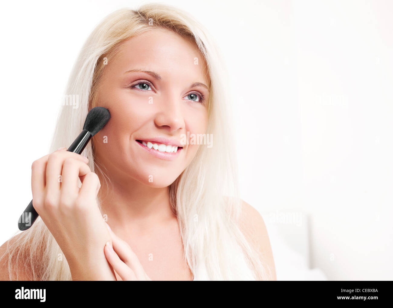 young woman applying cosmetics at home Stock Photo - Alamy