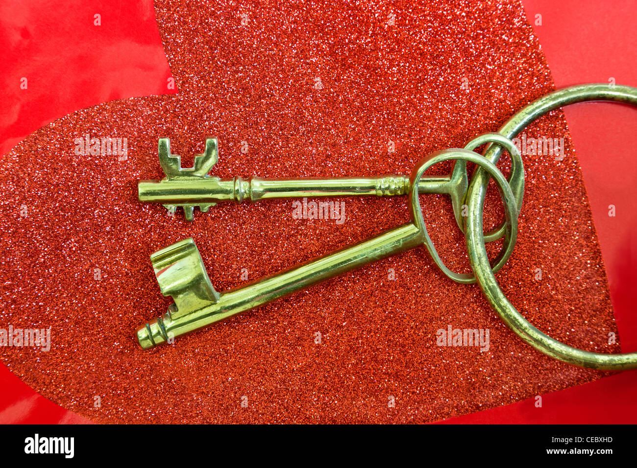 Two 'classic' brass keys, red heart Stock Photo - Alamy