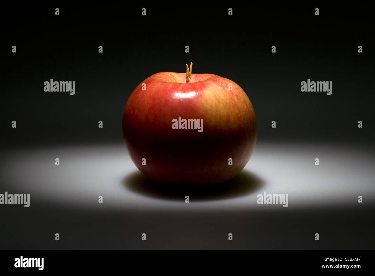 Black background with highlighted red apple in the center Stock Photo ...