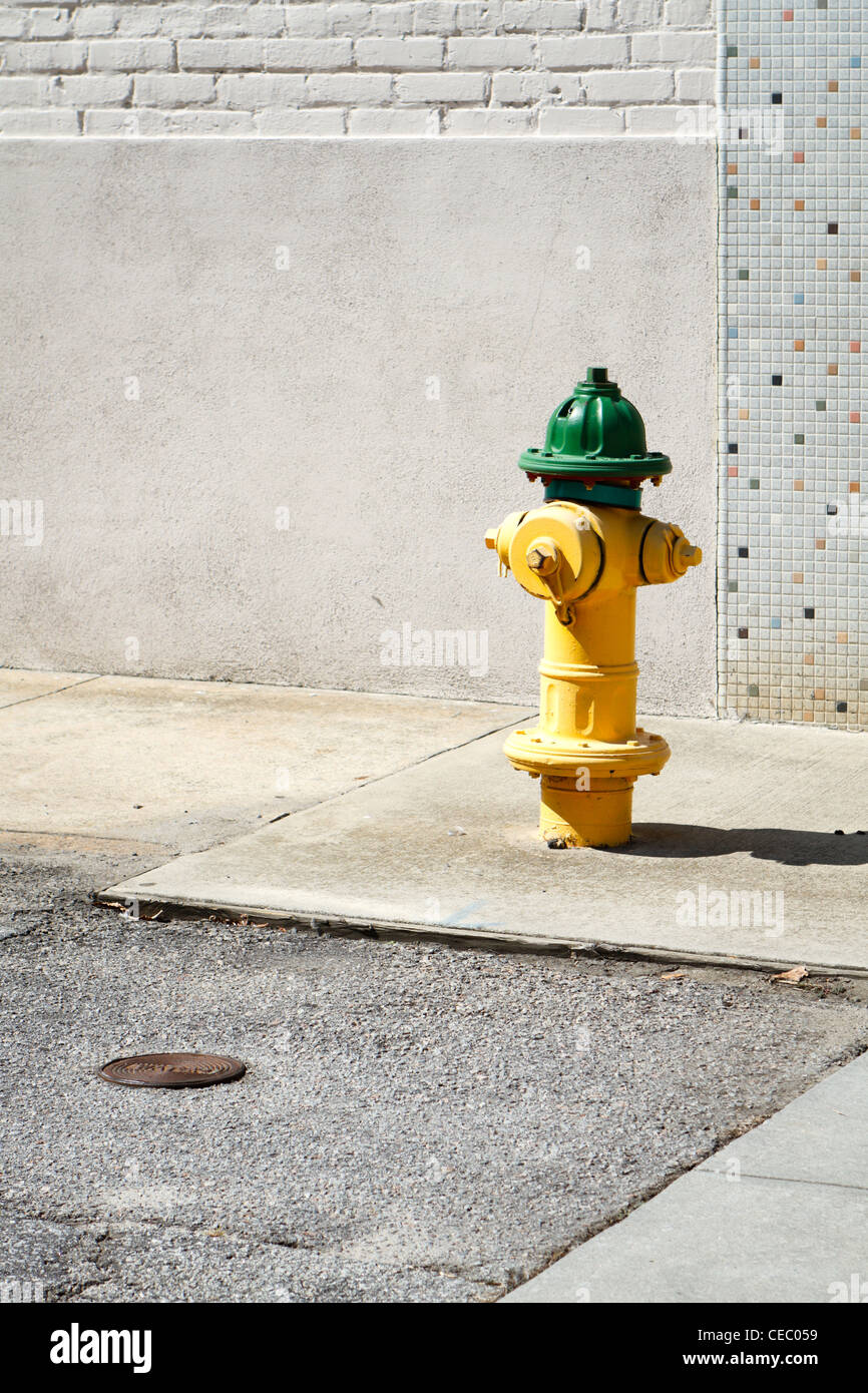 An American bright yellow & green fire hydrant on a city street corner ...