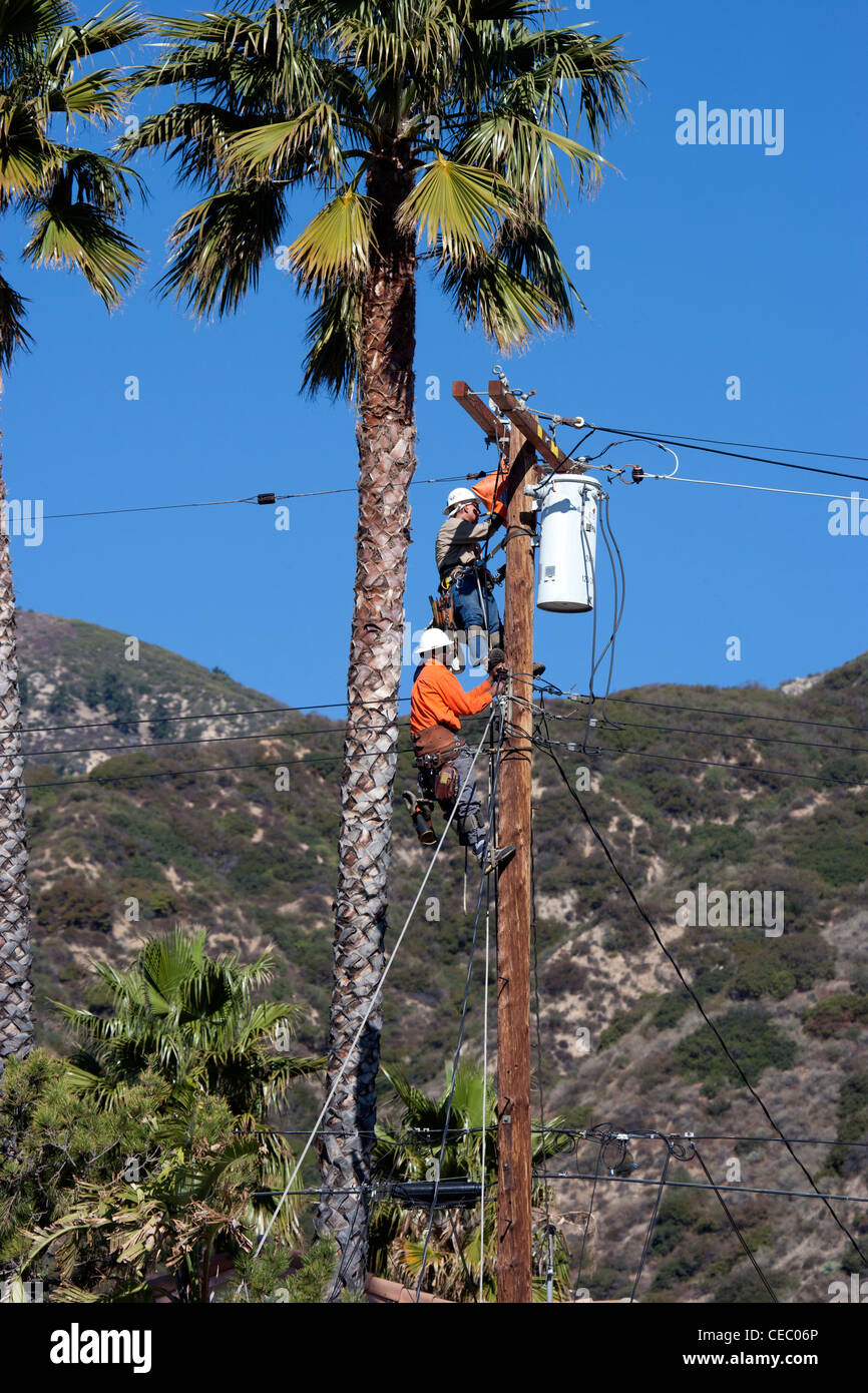 Two Men Working on Power Lines Stock Photo - Alamy