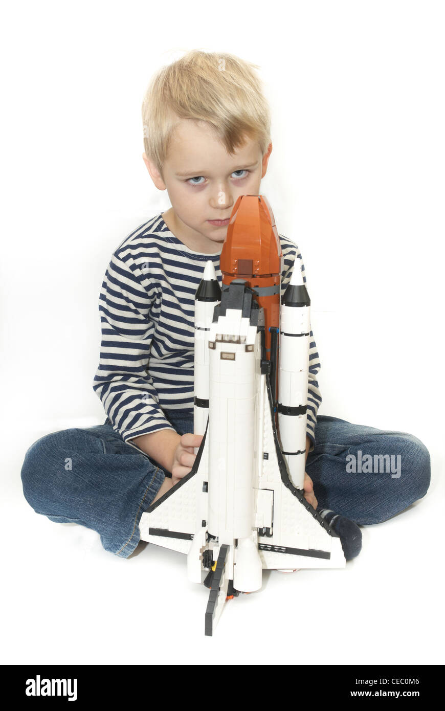 Child blond boy playing with Lego Space Shuttle model toy cut out Stock ...