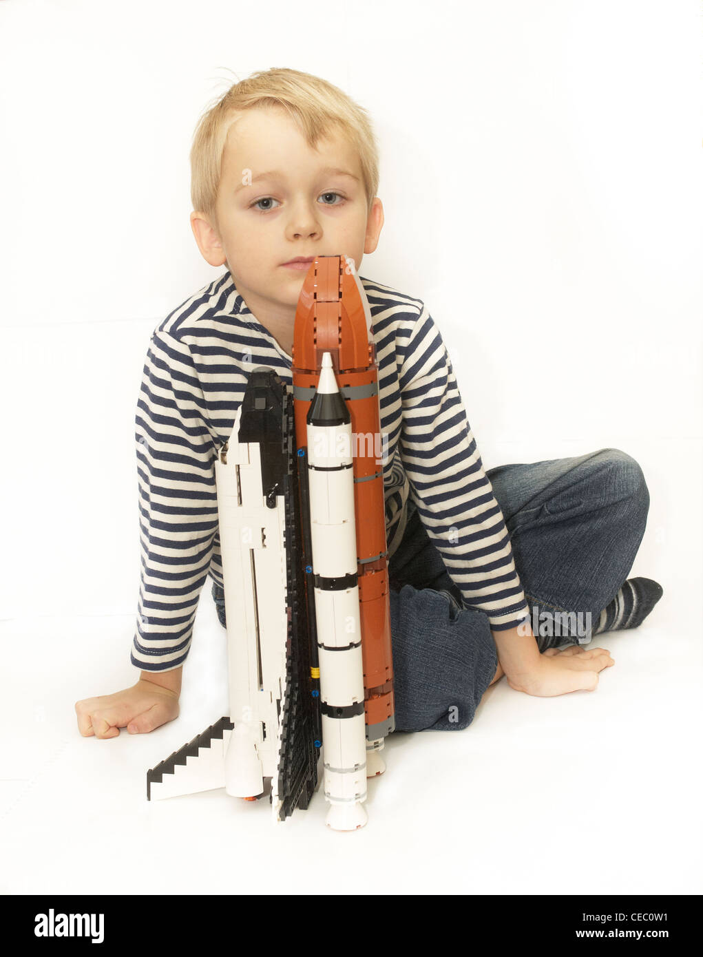 Child blond boy playing with Lego Space Shuttle model toy cut out Stock ...