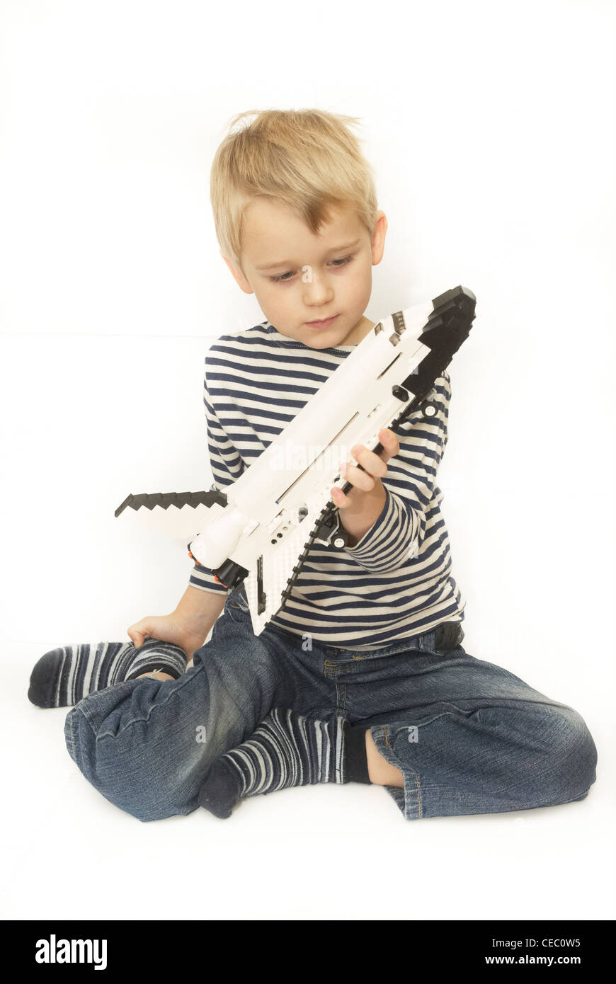 Child blond boy playing with Lego Space Shuttle model toy cut out Stock ...