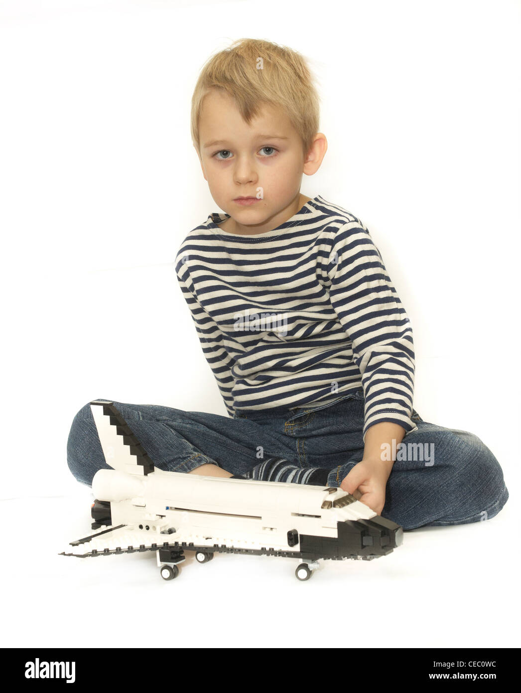 Child blond boy playing with Lego Space Shuttle model toy cut out Stock ...