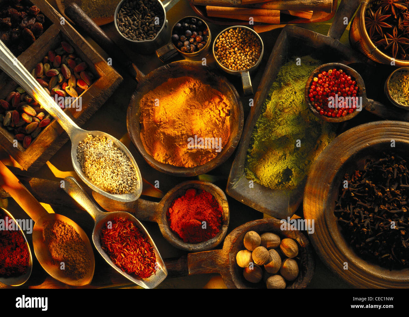 Assortment of spices in bowls, spoons, scoops, full frame, high angle ...