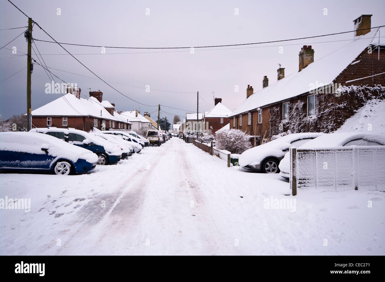 Snow Covered Residential Street With Houses and Parked Cars After Heavy ...