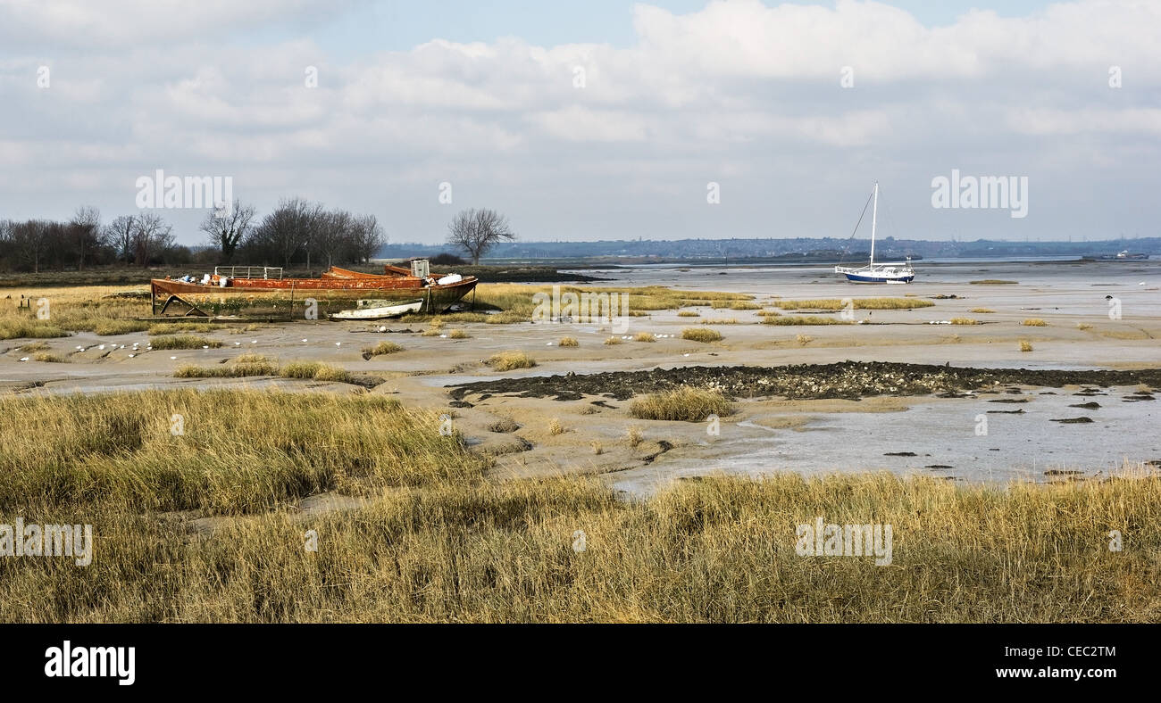 Abandoned barges beached on the mud at Sharps Green Bay on the Medway Estuary Stock Photo - Alamy