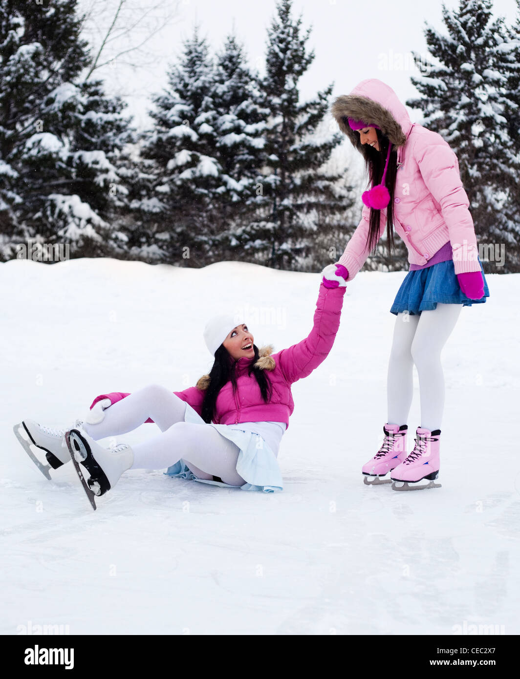 two happy young women ice skating on a winter day Stock Photo - Alamy