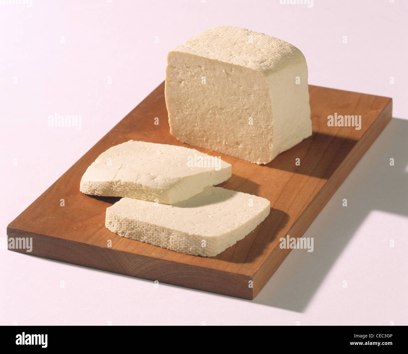 Cut out: Plain tofu on wooden plate Stock Photo - Alamy