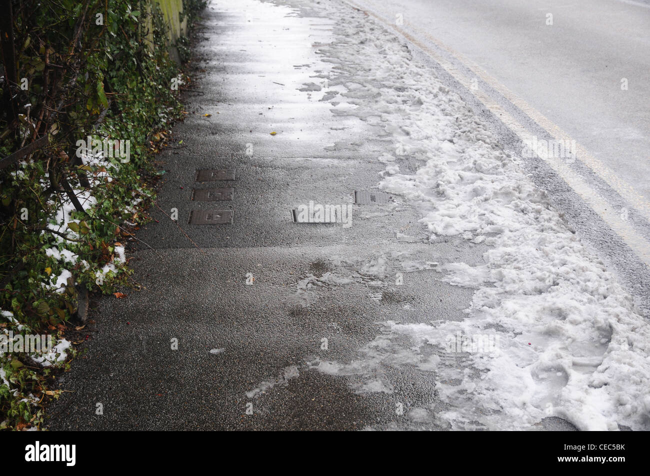 slush on edge of pavement, snow cleared from pavement, winter, UK Stock ...