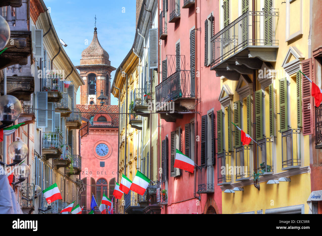 Ancient tower over commune building among old historic houses of Alba ...