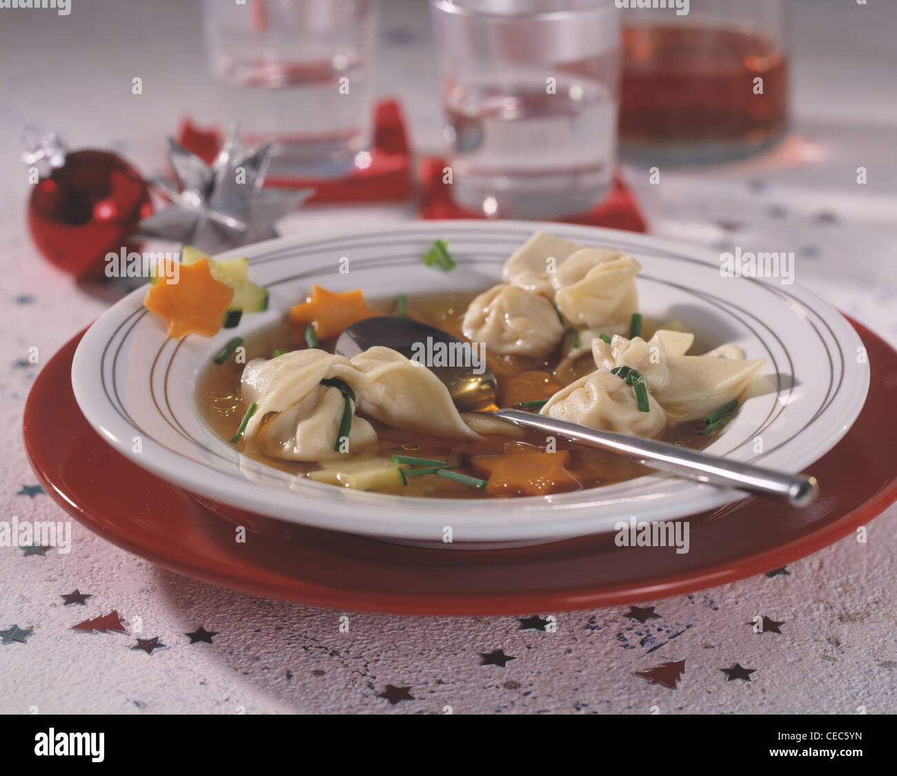 Port wine soup with filled noodle - bags and vegetable - plates Stock ...