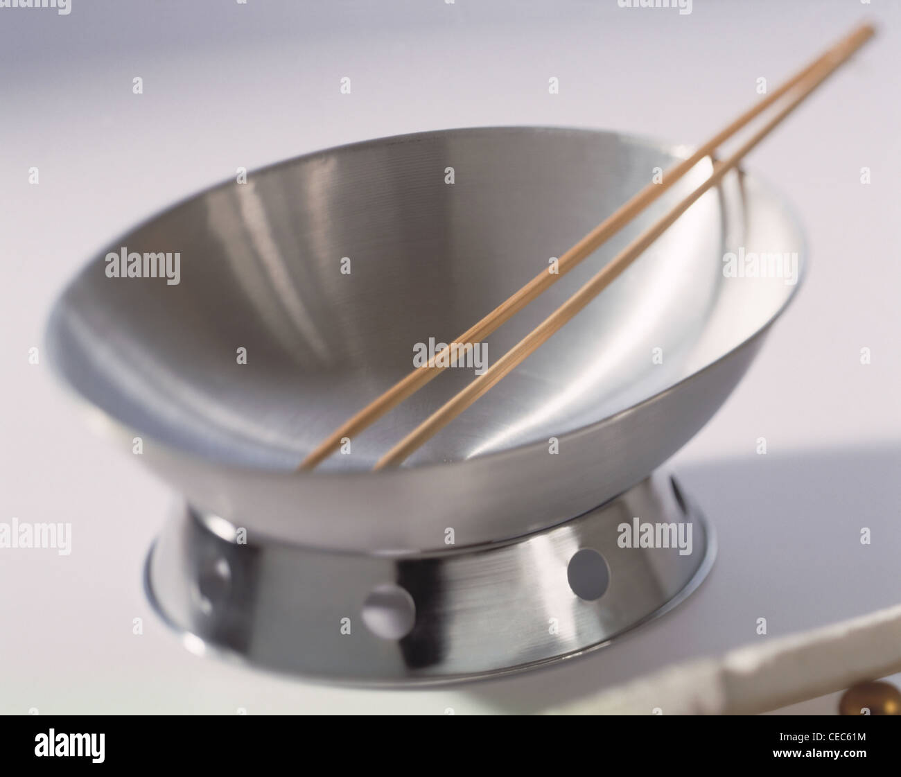 Cut out: Wok with chopsticks on a metal coaster Stock Photo - Alamy