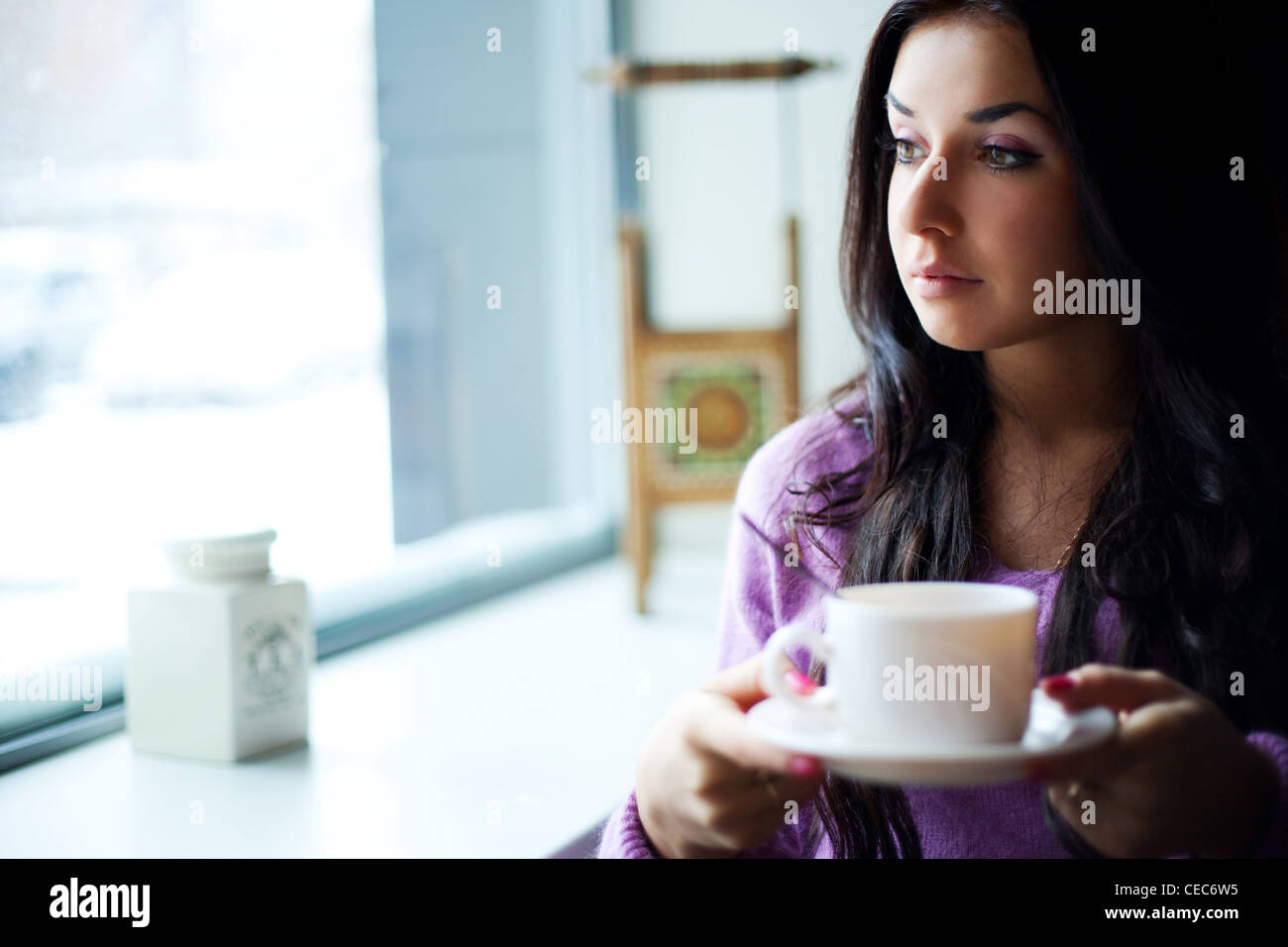 beautiful young woman drinking coffee Stock Photo - Alamy