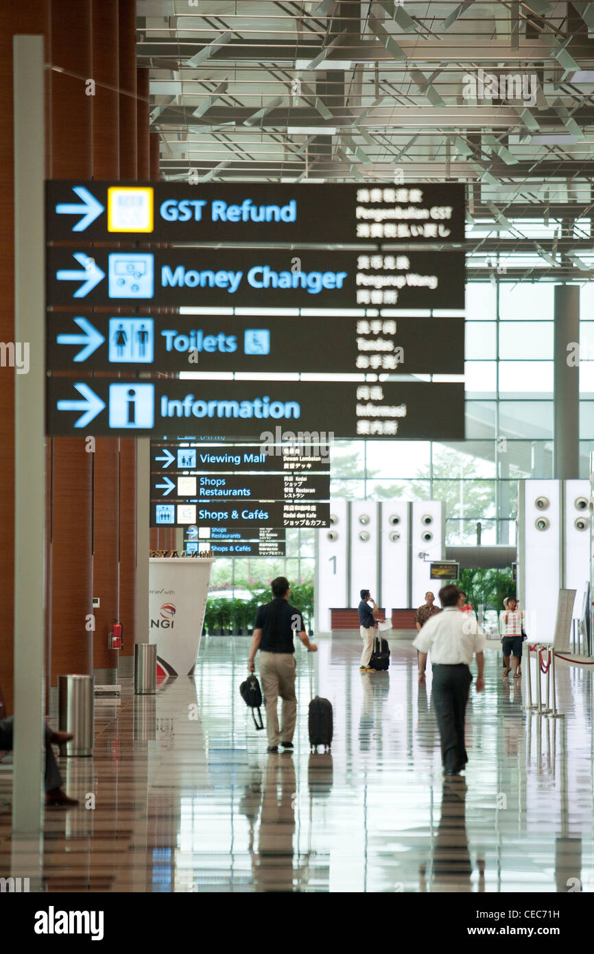 Passengers walk through the departures area of Terminal 3 at Changi ...