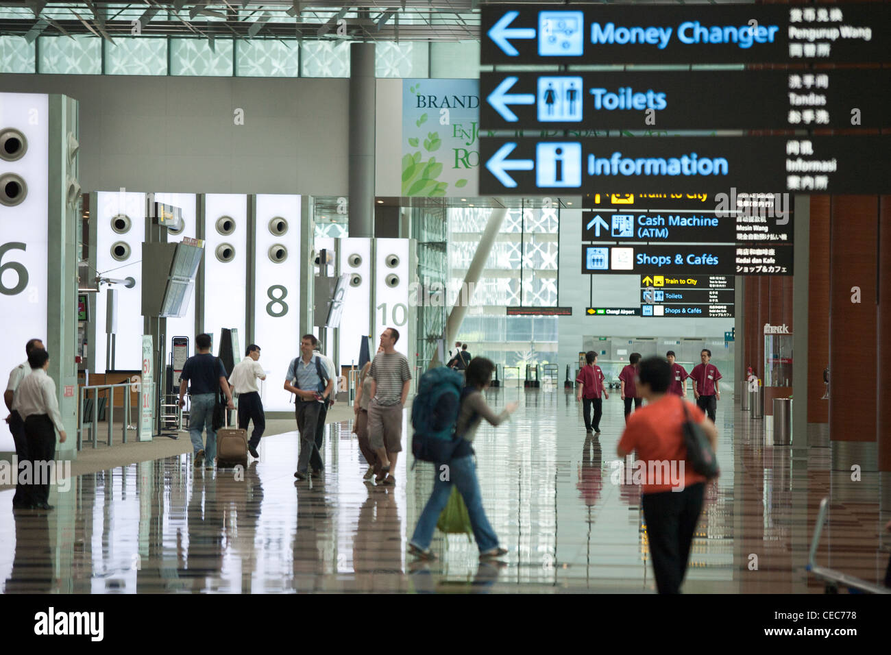 Passengers walk through the departures area of Terminal 3 at Changi ...