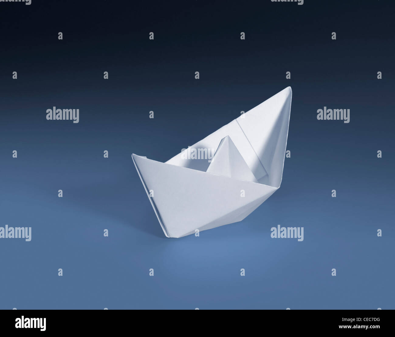 white paper ship in blue gradient back Stock Photo - Alamy