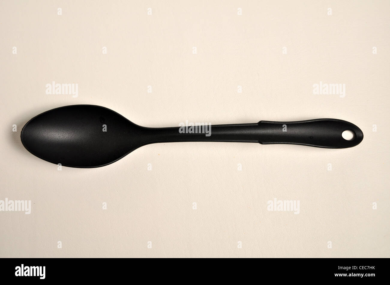 A serving spoon is laying on a white background Stock Photo - Alamy