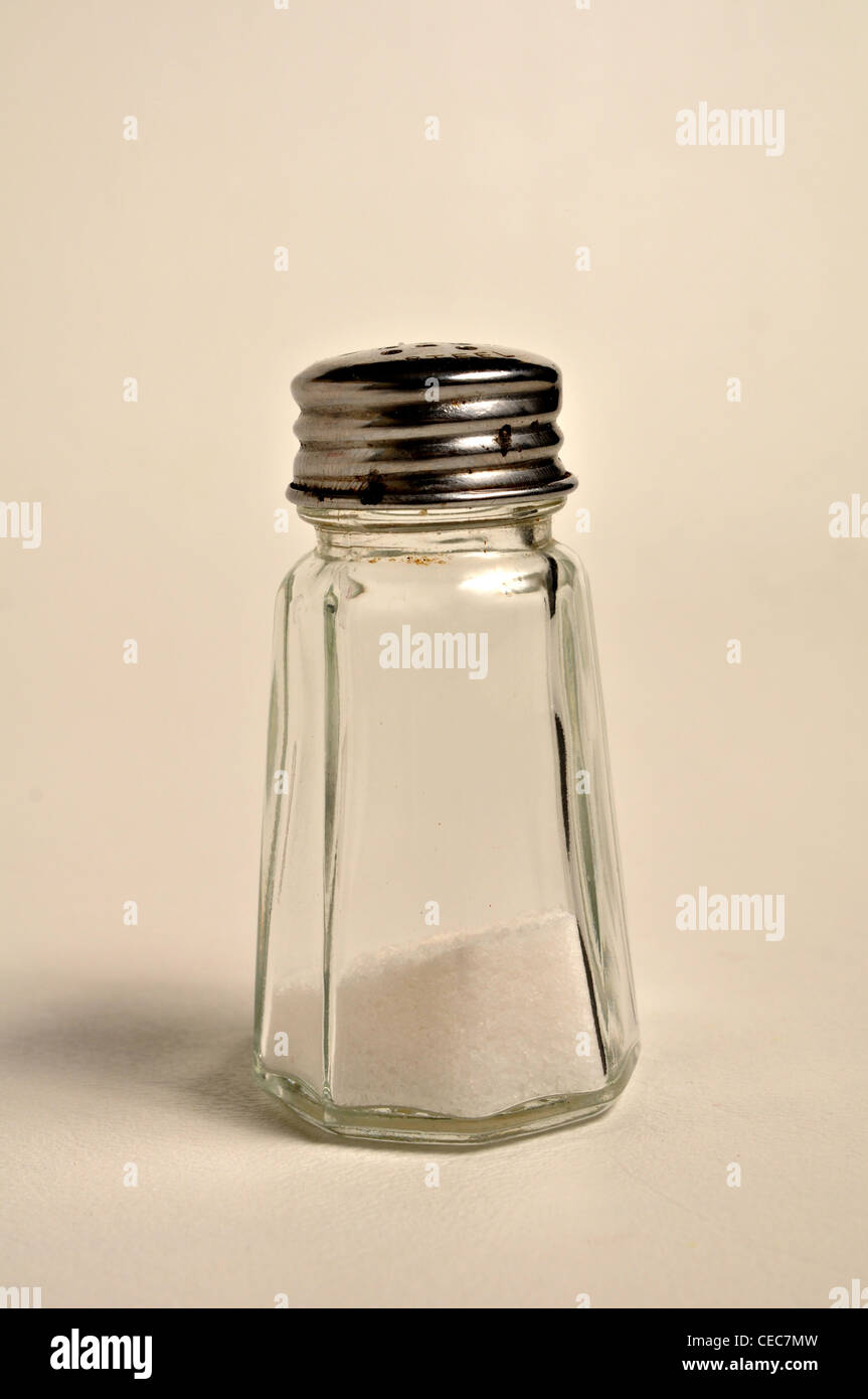 A salt shaker is standing upright on a white background Stock Photo - Alamy