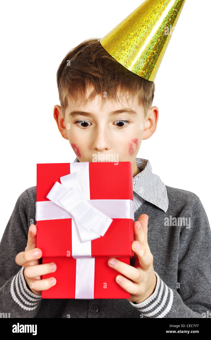A surprised child opening and looking inside a gift box over white ...