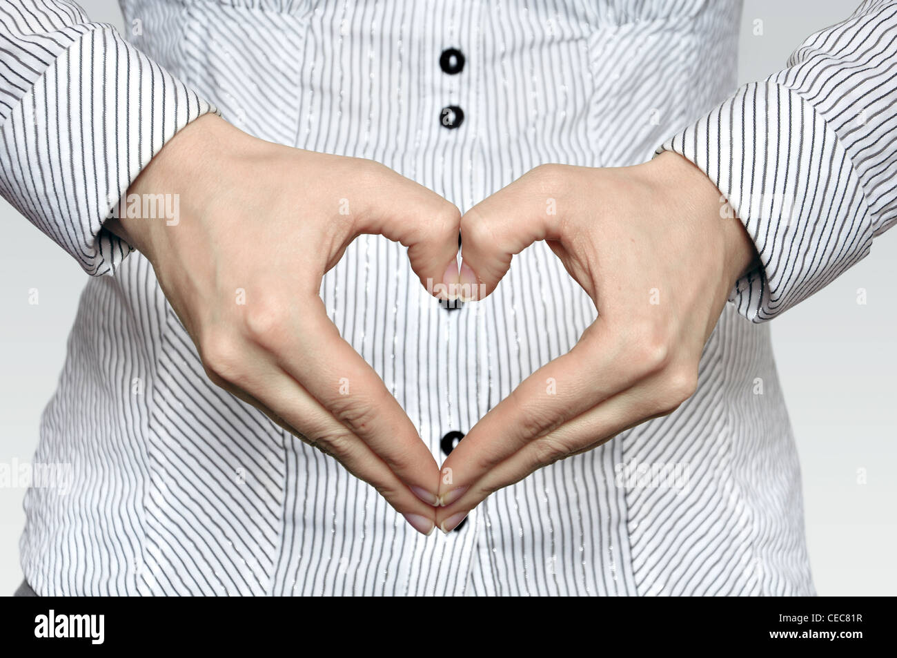 Female hand making sign heart Stock Photo - Alamy
