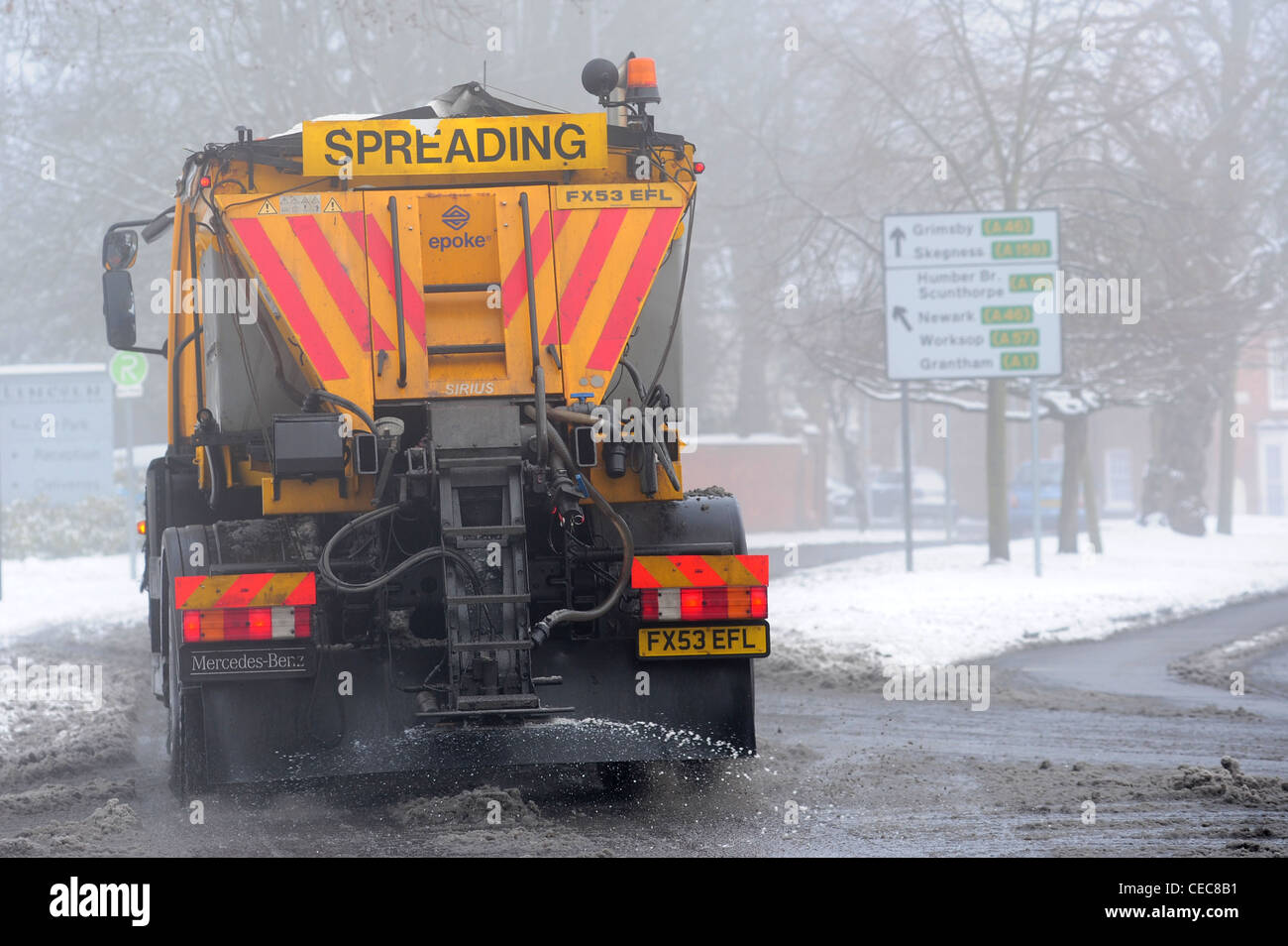 A gritter lorry spreads salt in Nettleham Road, Lincoln, Lincolnshire ...