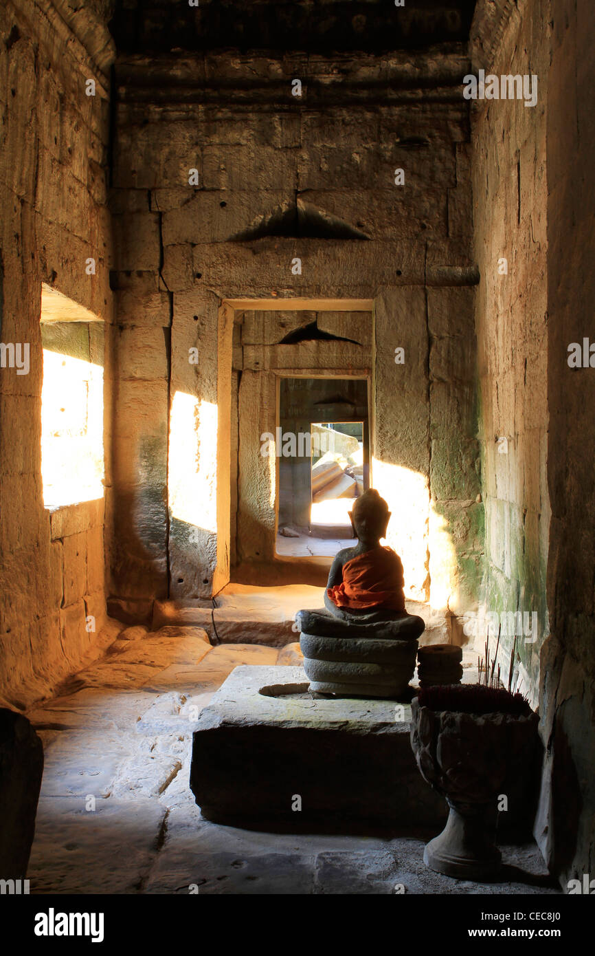 A Buddha statue at the Ta Prohm temple in Siem Reap, Cambodia with ...