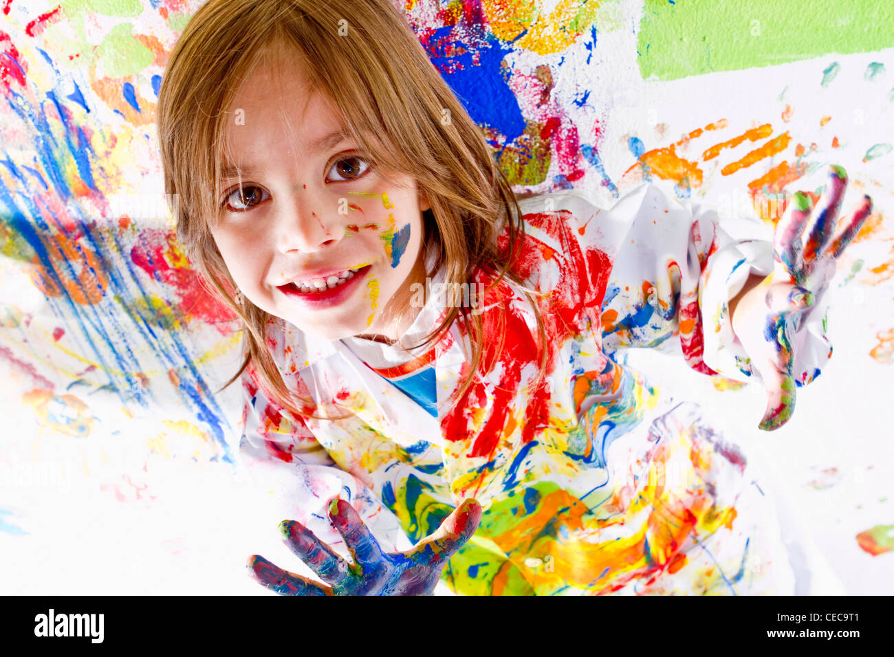 Messy Hispanic girl finger painting Stock Photo - Alamy