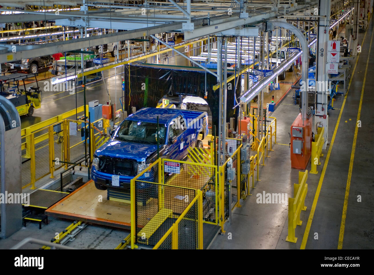 Partially completed F-150 pickup trucks move down the production line ...