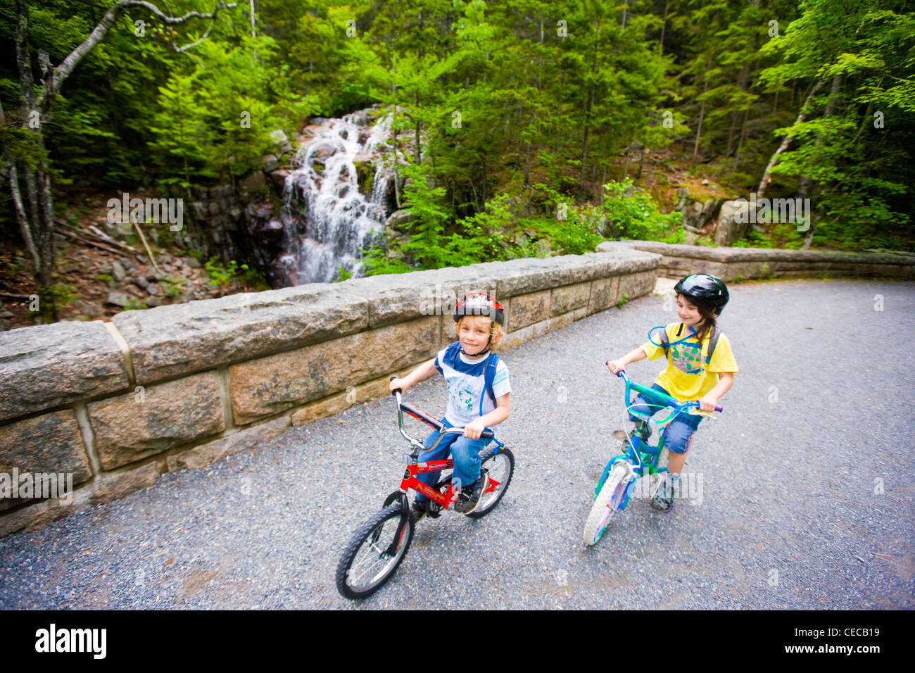 two young bike riders on a carriage road in Maine's Acadia National ...